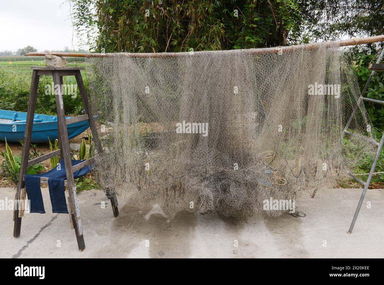 A large fishing net hanged on the roadside in Bàn Thạch, Hoi An ...