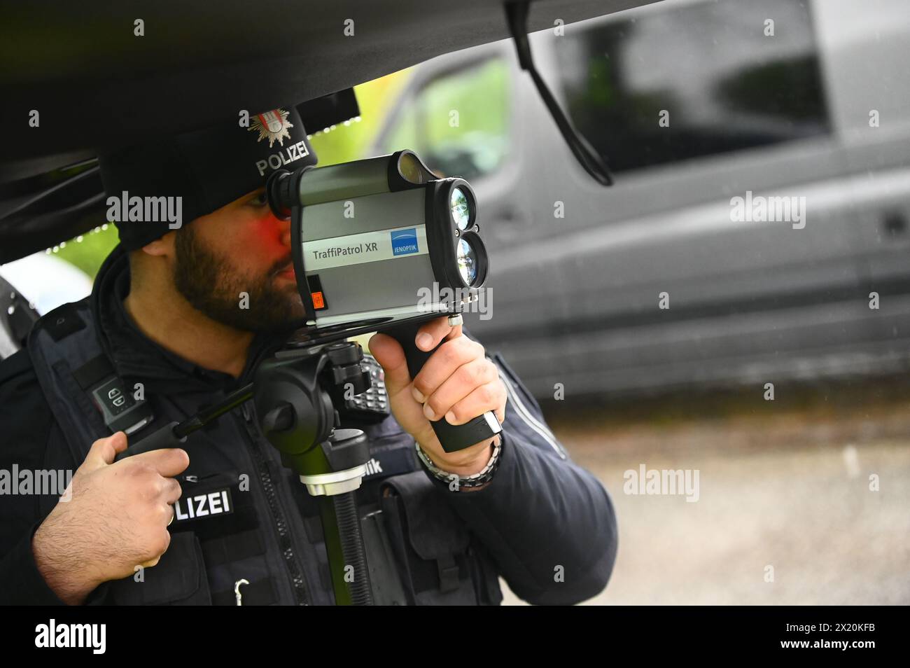Hamburg, Germany. 19th Apr, 2024. A police officer uses a measuring ...