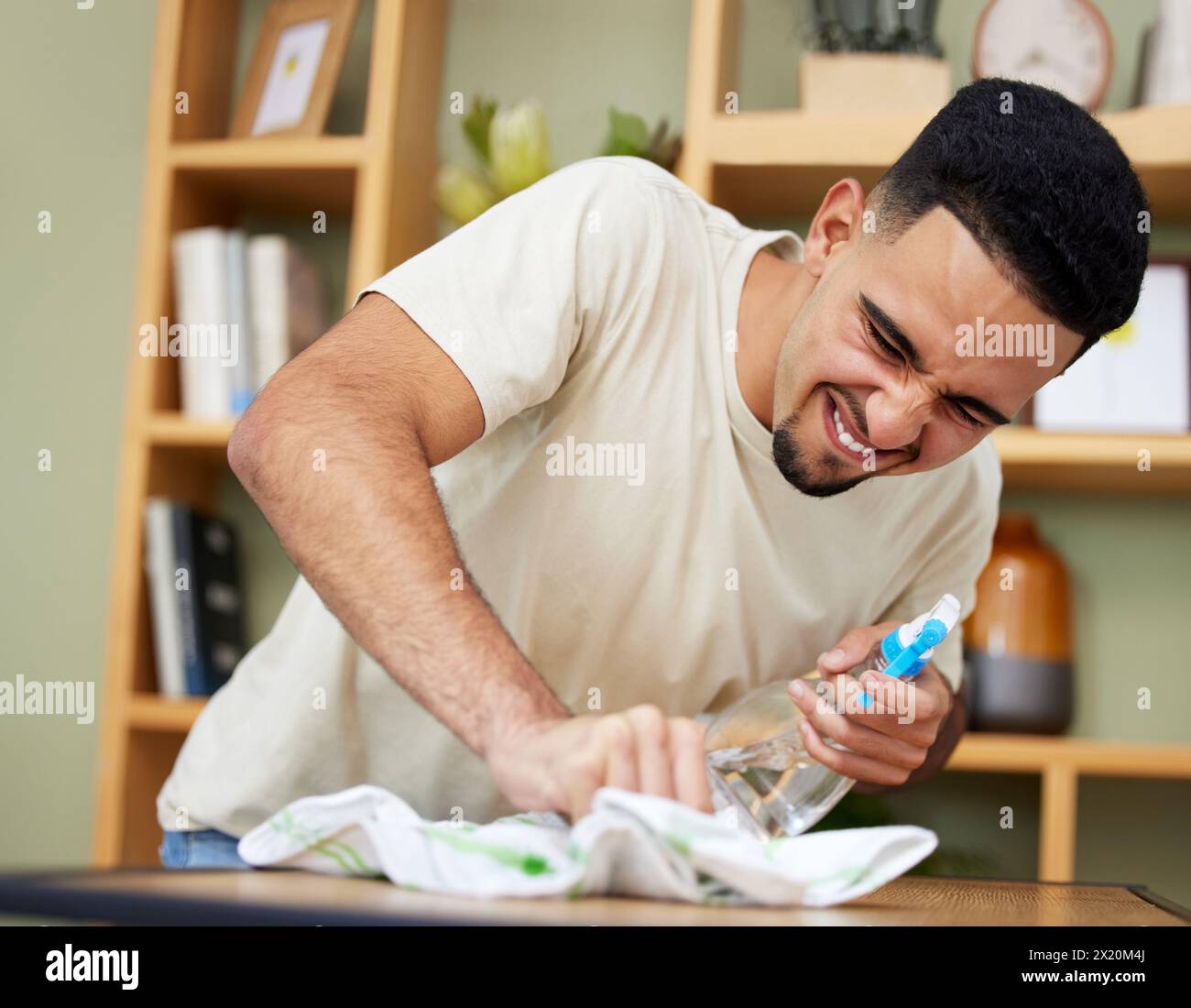 Cleaning, table and man in home to wipe with spray for chores ...