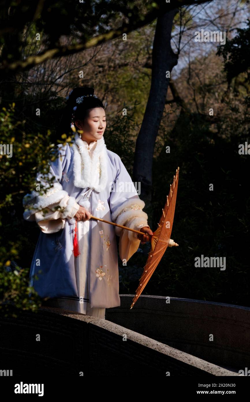 A woman dressed in traditional hanfu clothings poses for photo at the ...