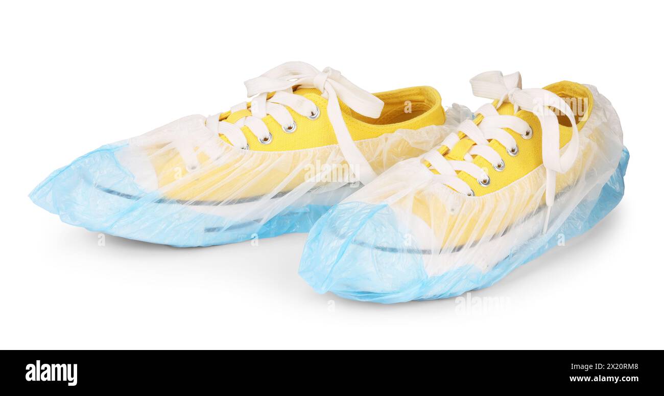 Sneakers in blue shoe covers isolated on white Stock Photo - Alamy