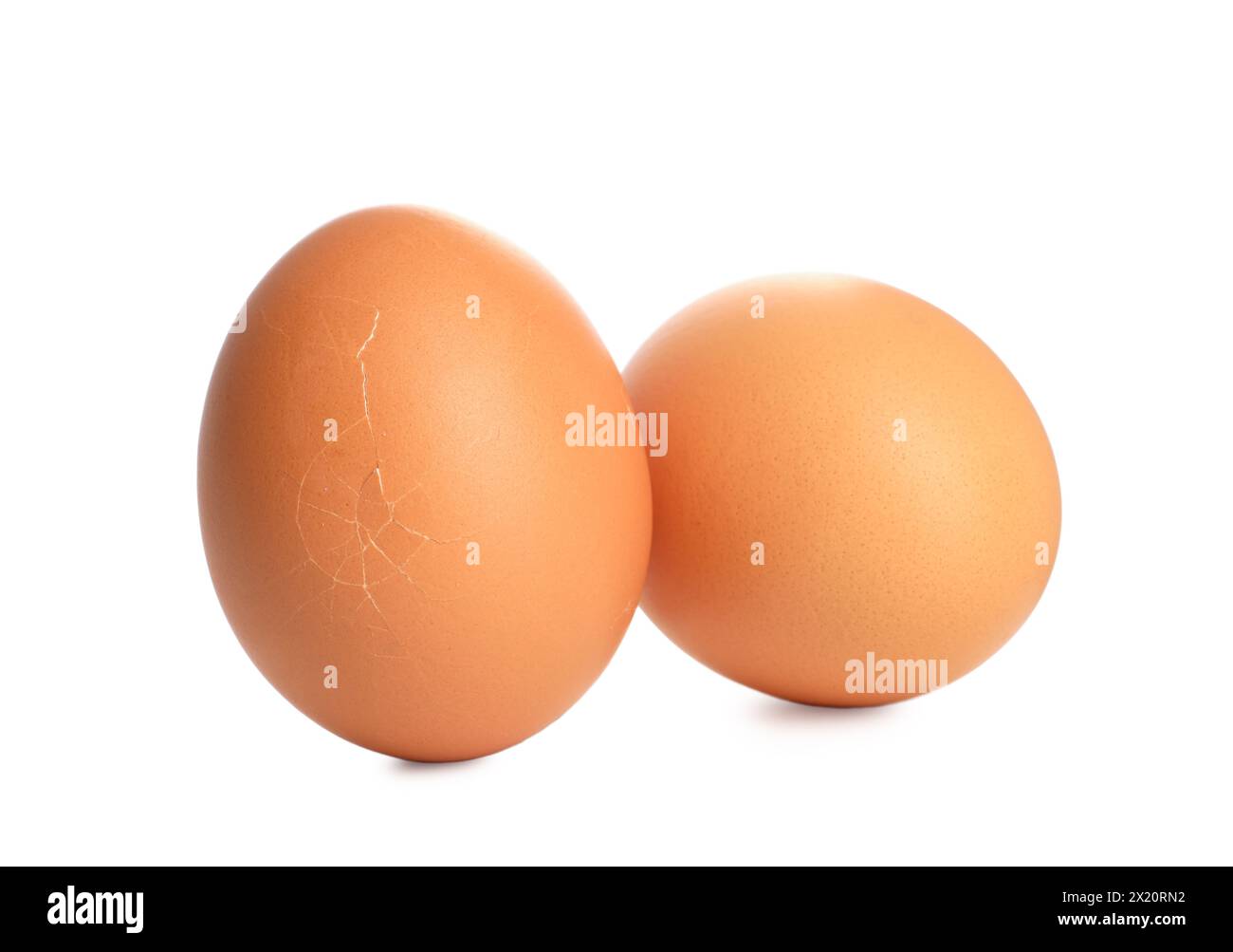 Two raw chicken eggs isolated on white Stock Photo - Alamy