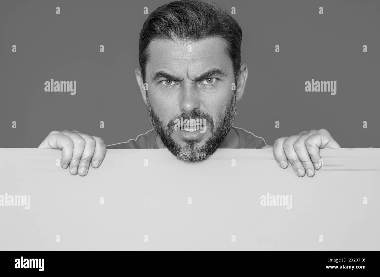 Angry man holds sign blank card. Placard ready for your product ...