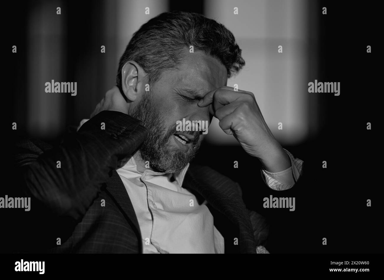 Headache, tiredness and stress. Close up portrait of man in suit got ...