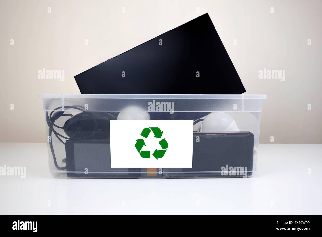 Electronics and batteries in a recycling bin with a recycle symbol ...