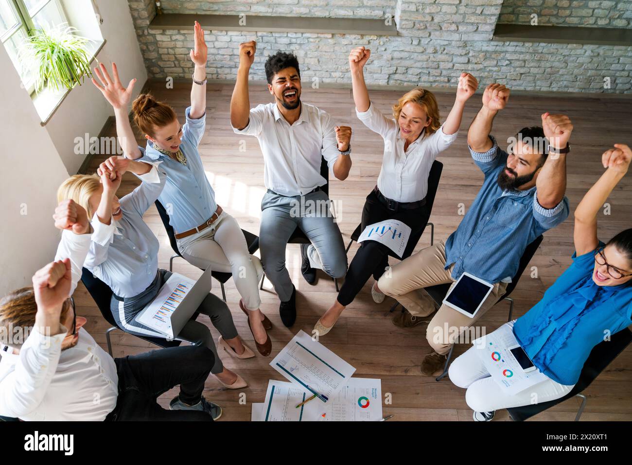 Entrepreneurs and business people achieving goals, celebrating on team ...