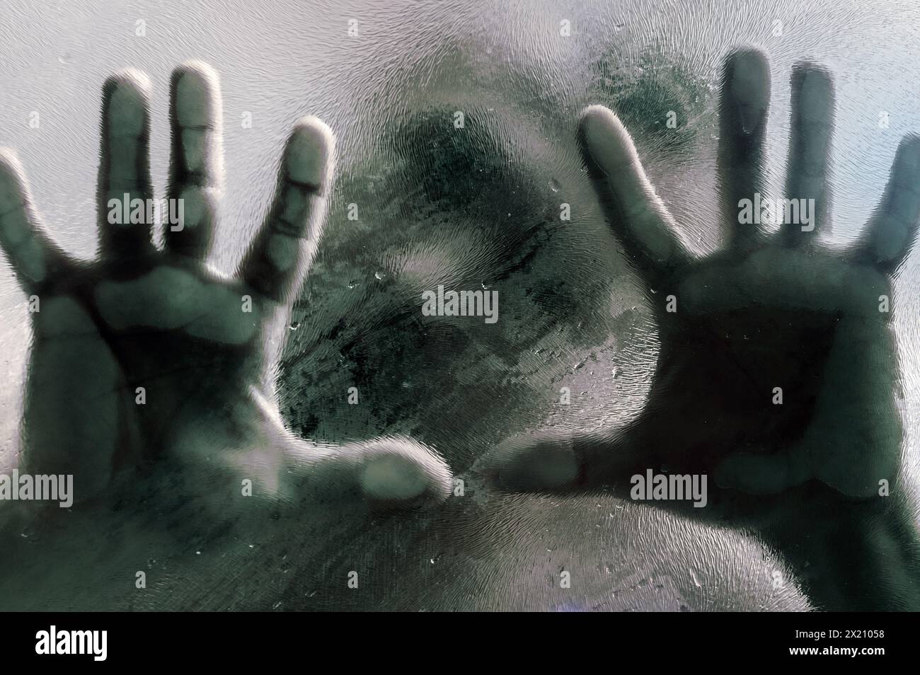 Mans figure with hands pressed against frosted glass. Shadow of a man ...