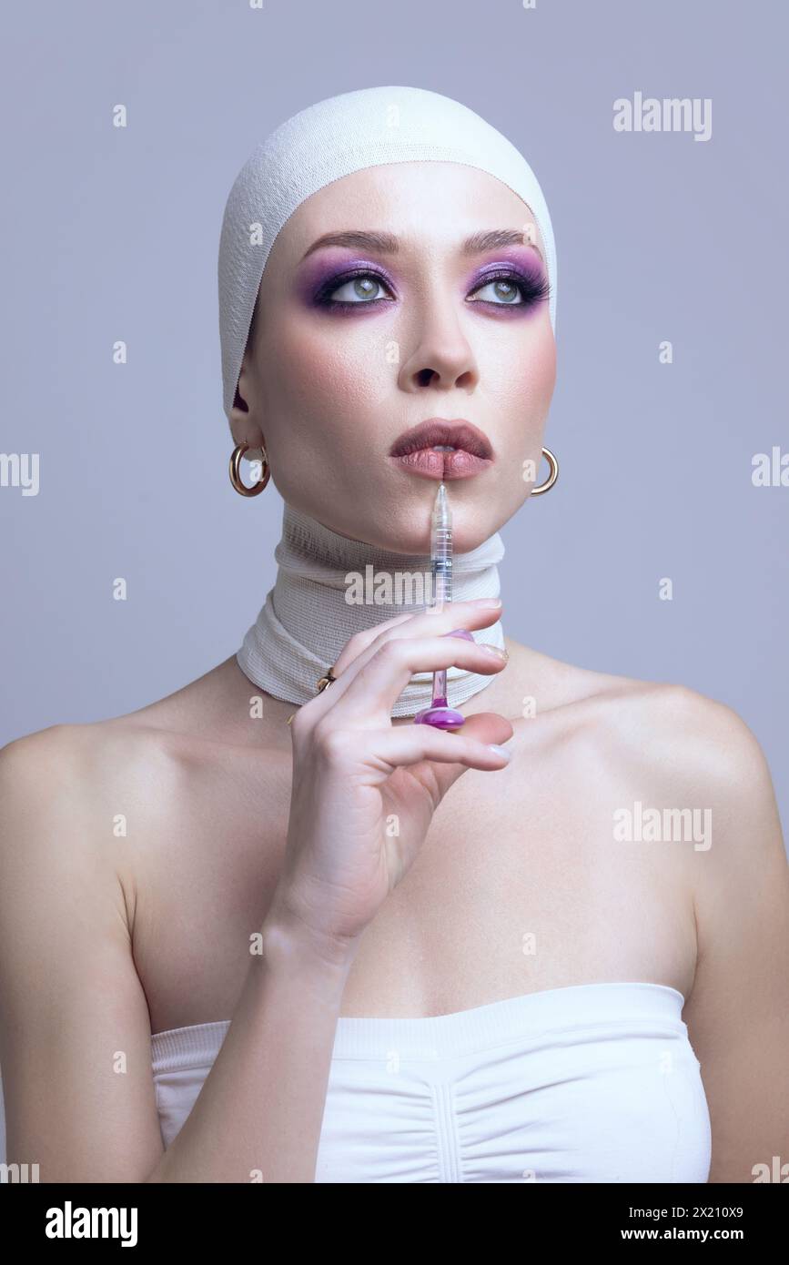 Following beauty standards. Young elegant woman doing lip augmentation ...