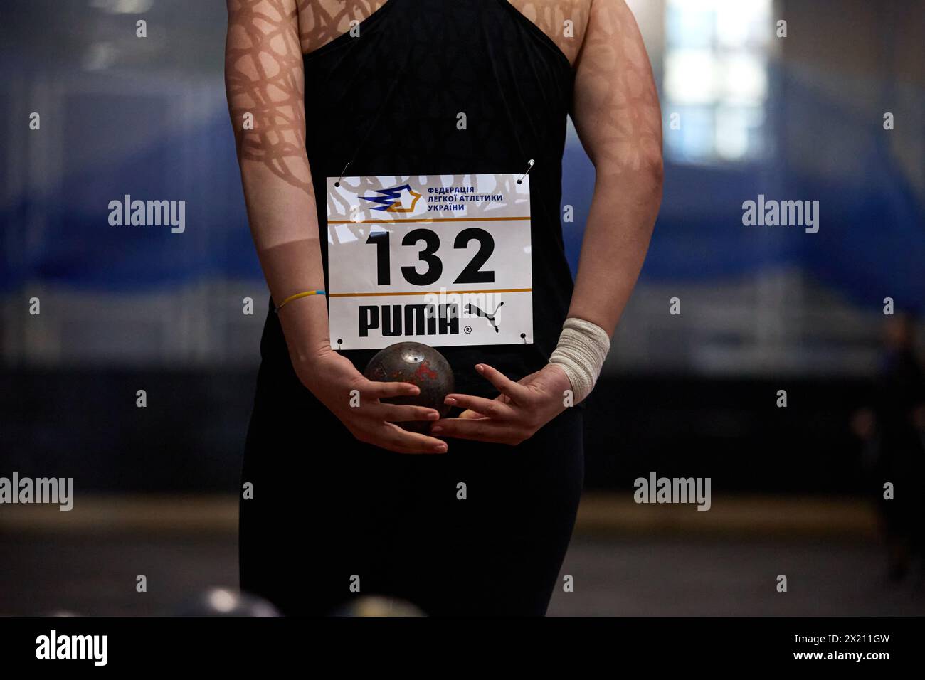 female shot putter holds an iron 4 kg shot at Indoor Championship of ...