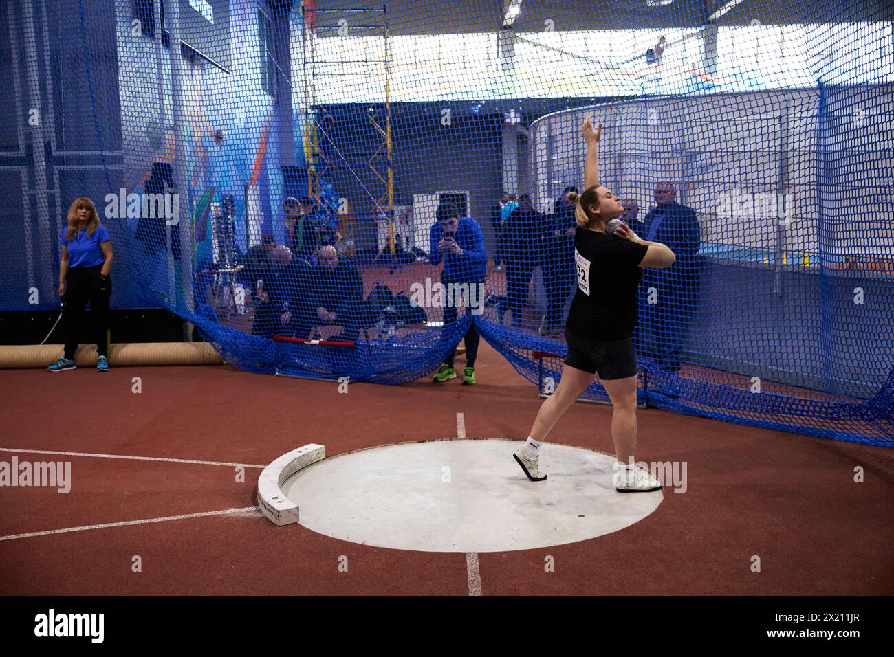 Professional shot put competition. Female putter preparing to throw a 4 ...