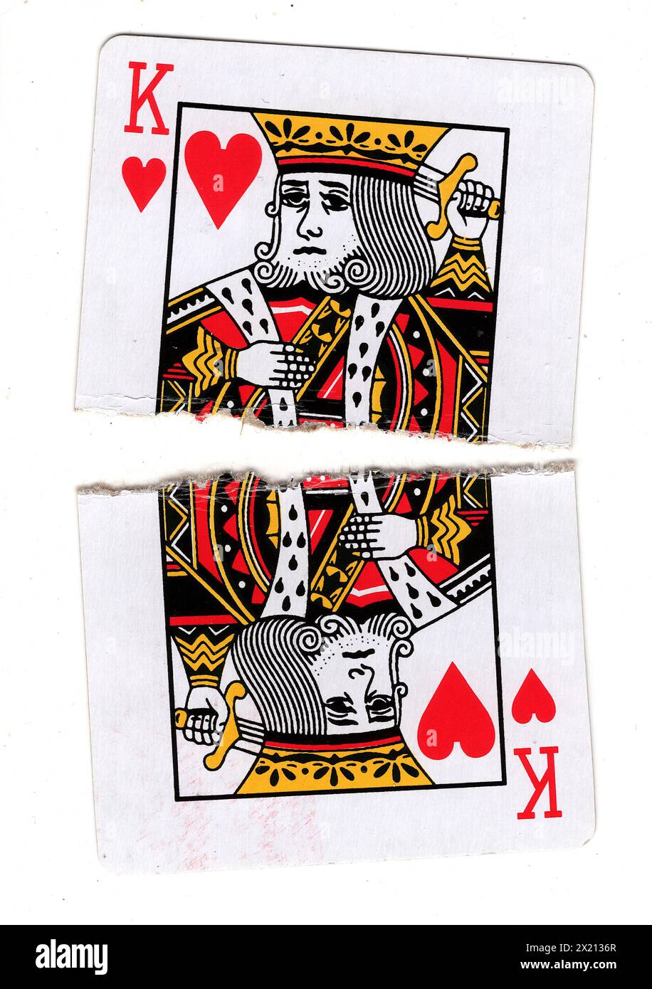 A king of hearts playing card torn in half on a white background Stock ...