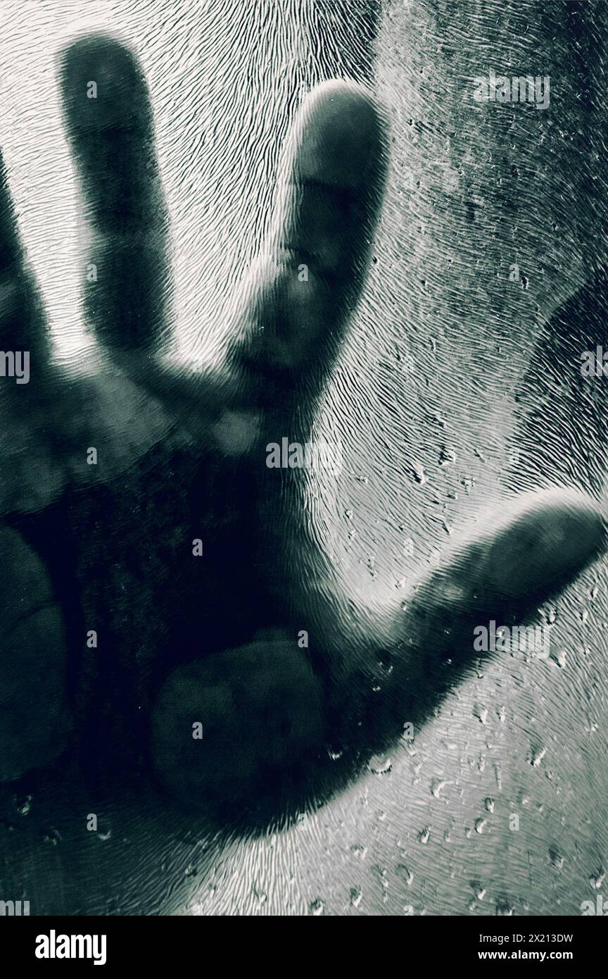 Mans figure with hands pressed against frosted glass. Shadow of a man behind the matte glass ...