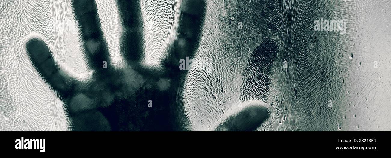 Mans figure with hands pressed against frosted glass. Shadow of a man behind the matte glass ...