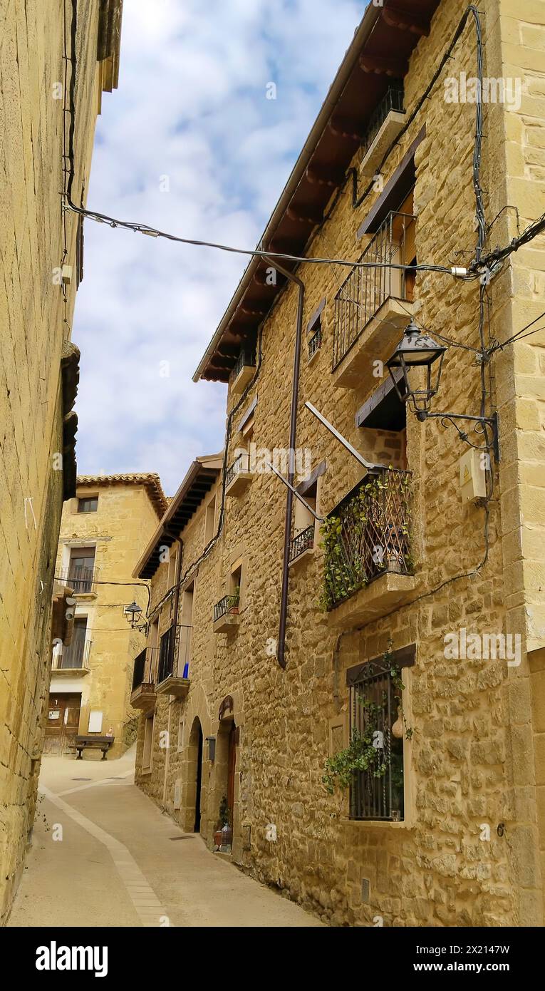 A narrow alleyway with a building on the left and another building on ...