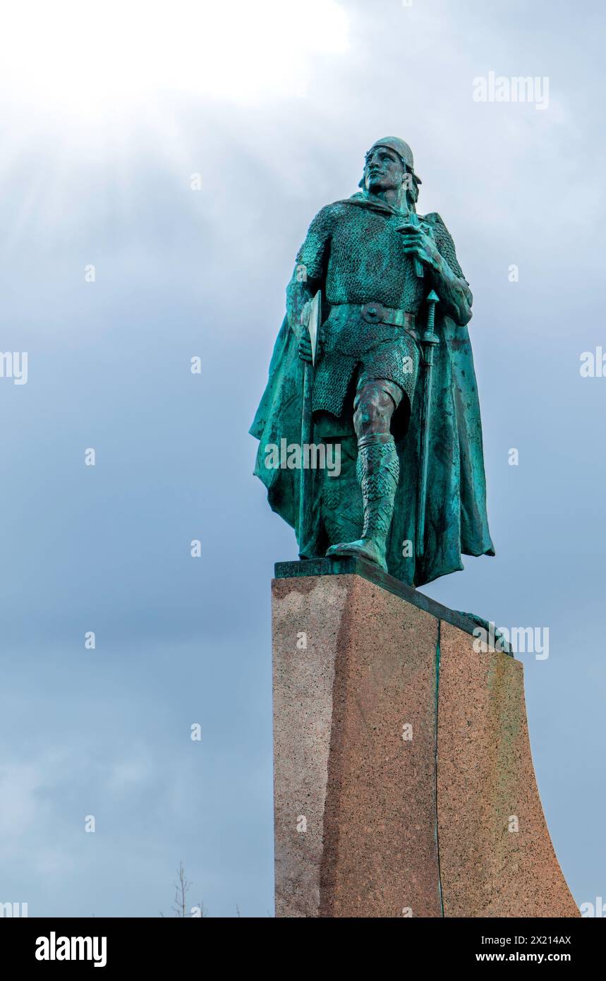 A statue of a Norse explorer with an axe is standing on a stone ...