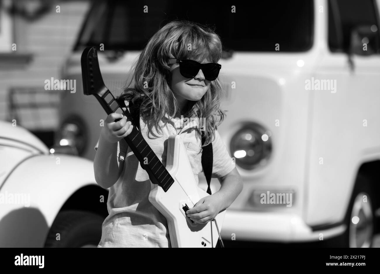 Funny rock child with guitar. Little boy in sunglasses. Kids music ...