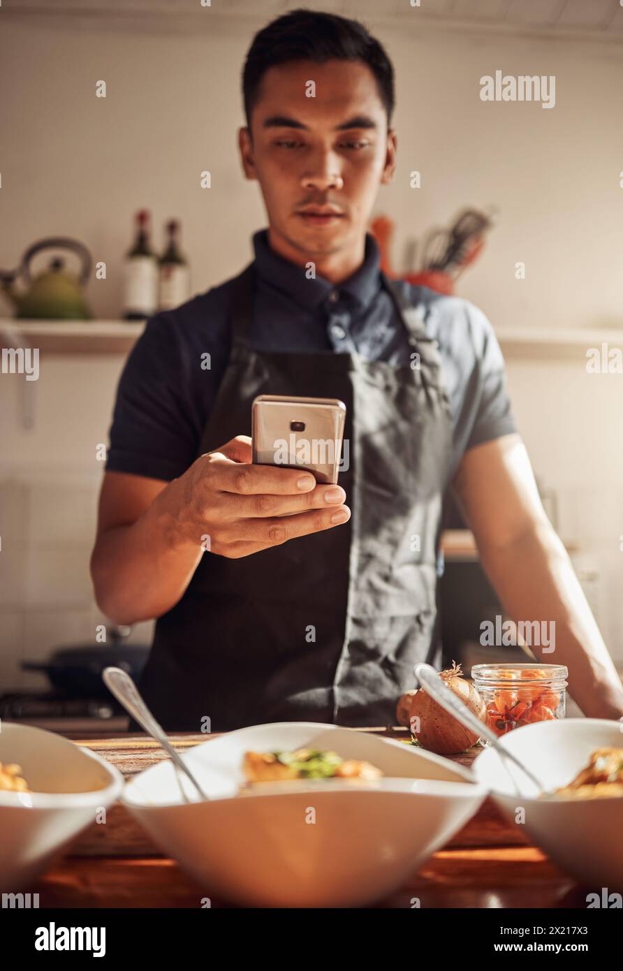 Person, man and smartphone with food or meal, kitchen and culinary art ...
