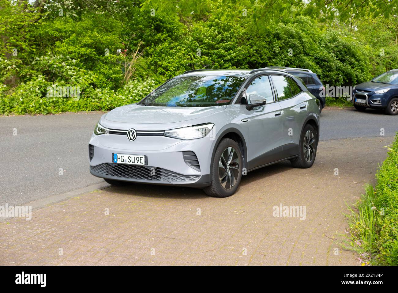 electric light blue car Volkswagen ID.4 on street, technology German ...