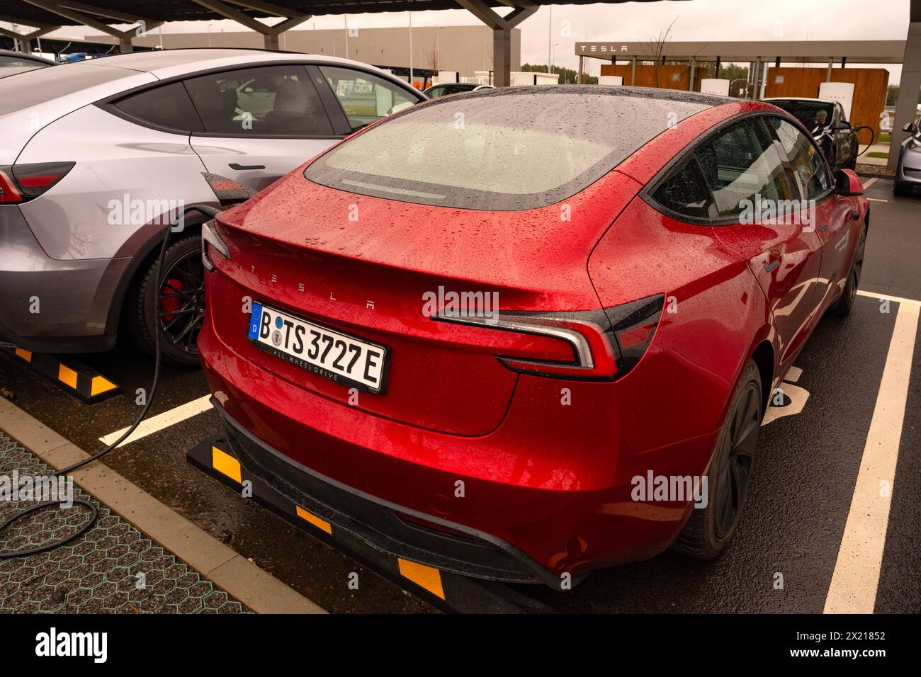 Tesla Model 3 Highland faceliftred vehicles parked in public parking ...