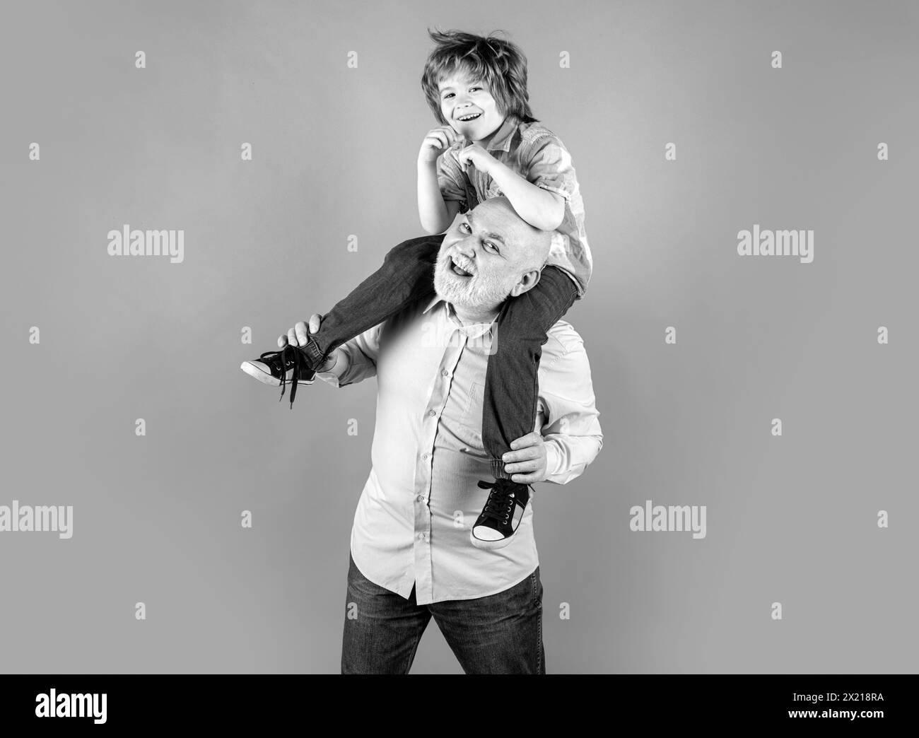 Child boy and grandfather with funny face isolated piggyback ride ...