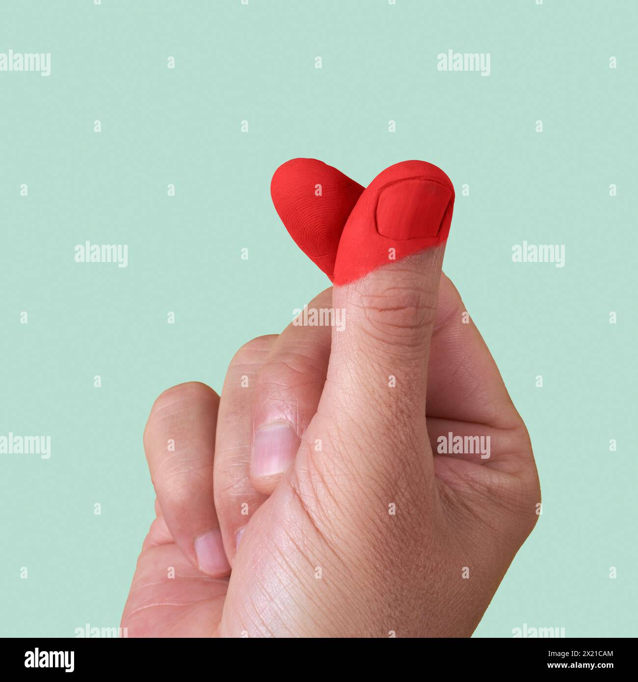 closeup of the hand of a man doing the finger heart gesture, with his ...