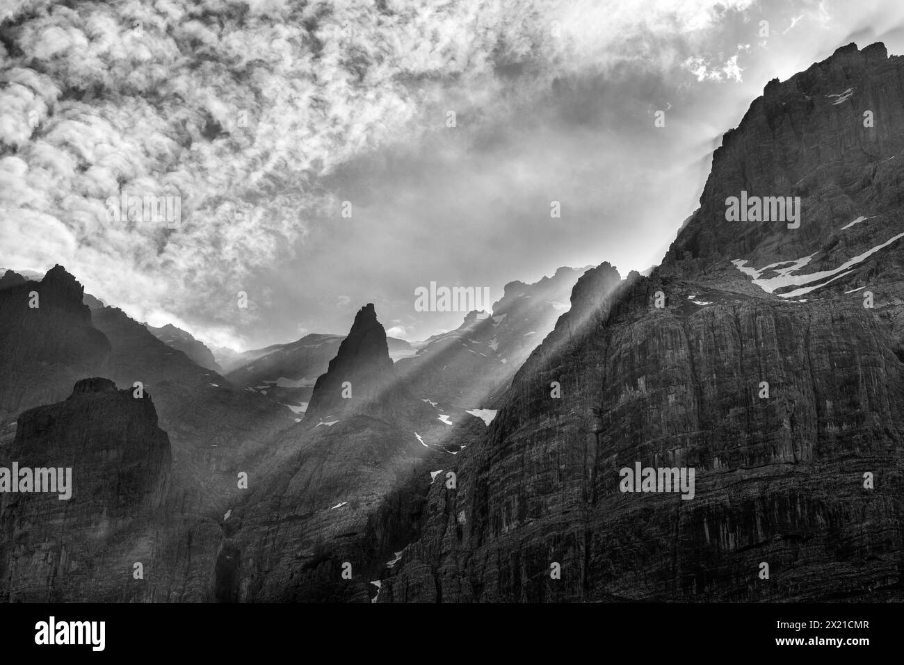 Stripes of light fall into cirque with rock tower, Malga Flavona ...