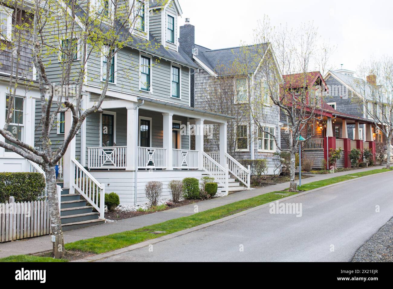 Cozy homes line a peaceful suburban street in spring Stock Photo - Alamy