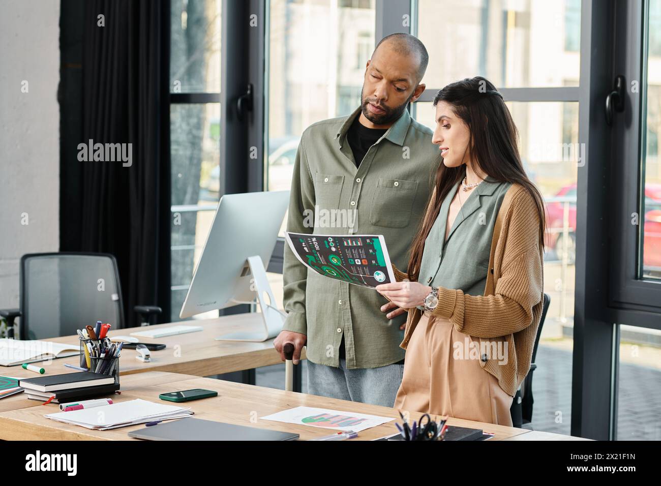 A man with myasthenia gravis and a woman in a corporate setting examine ...