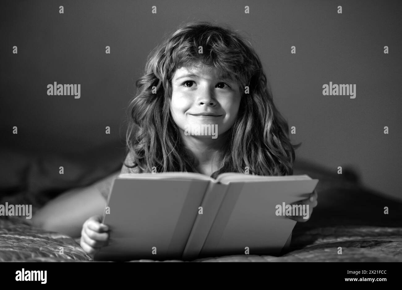 Child boy reading book. Child reading a book in bed before going to ...