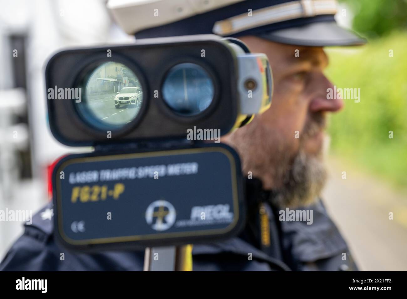 19 April 2024, Bavaria, Nuremberg: A car is reflected in the lens of a ...