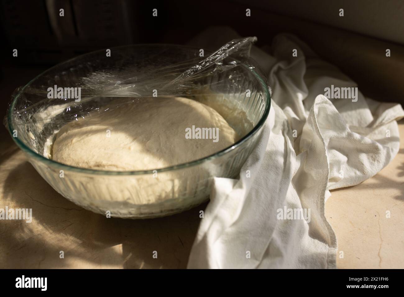 sourdough bread proofing on kitchen counter in with dramatic light ...