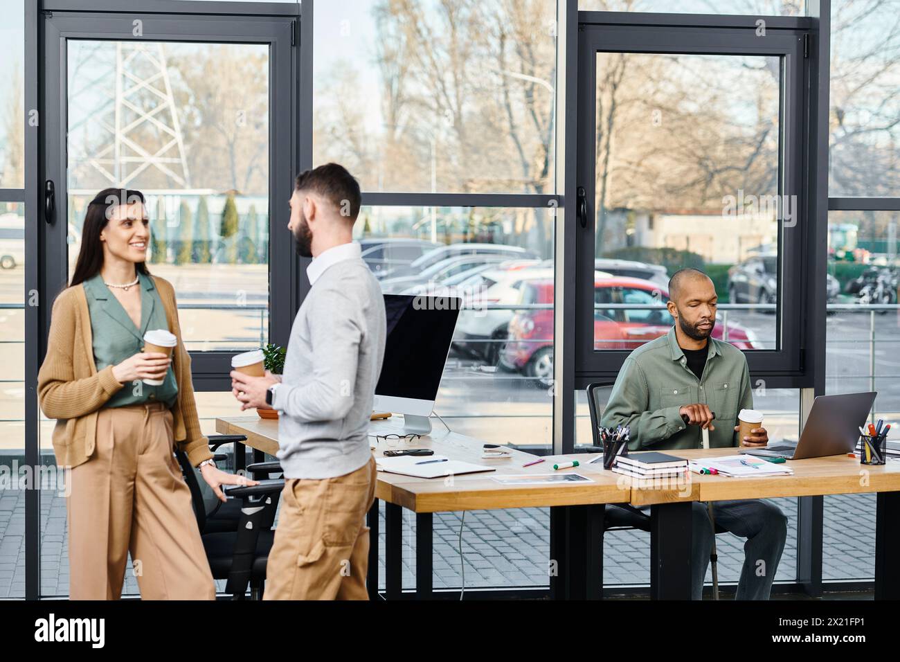 A diverse group of professionals brainstorm ideas and work on a project ...