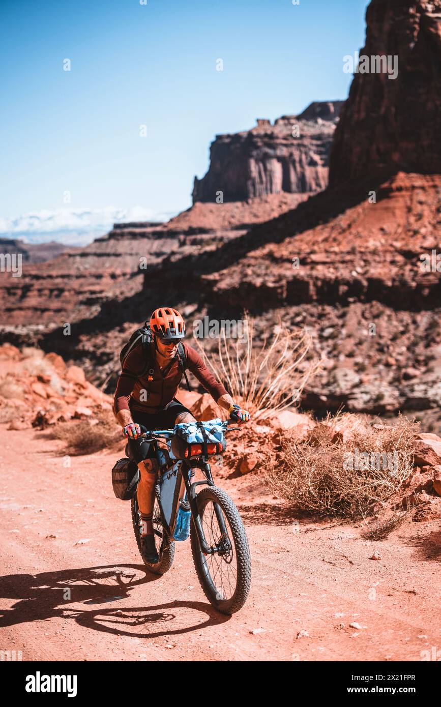 Man on heavily packed mountain bike on White Rim Trail, Moab Utah Stock ...