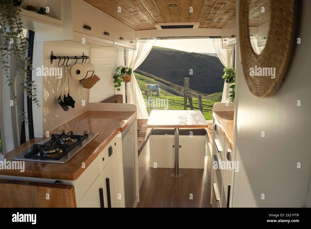 Interior of a cozy camper with Nordic design in a bucolic landscape ...