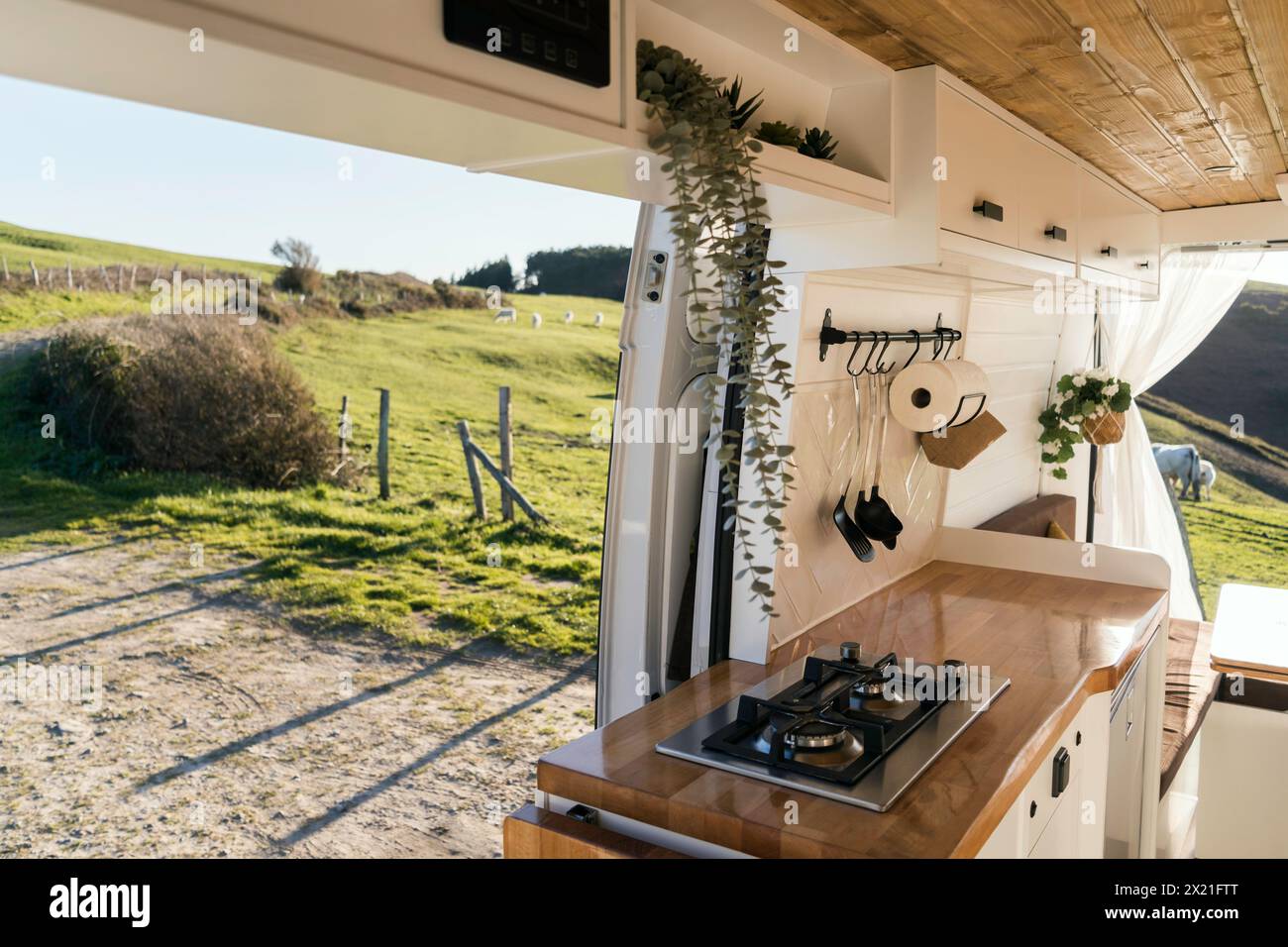 Interior of a cozy camper with Nordic design in a bucolic landscape ...