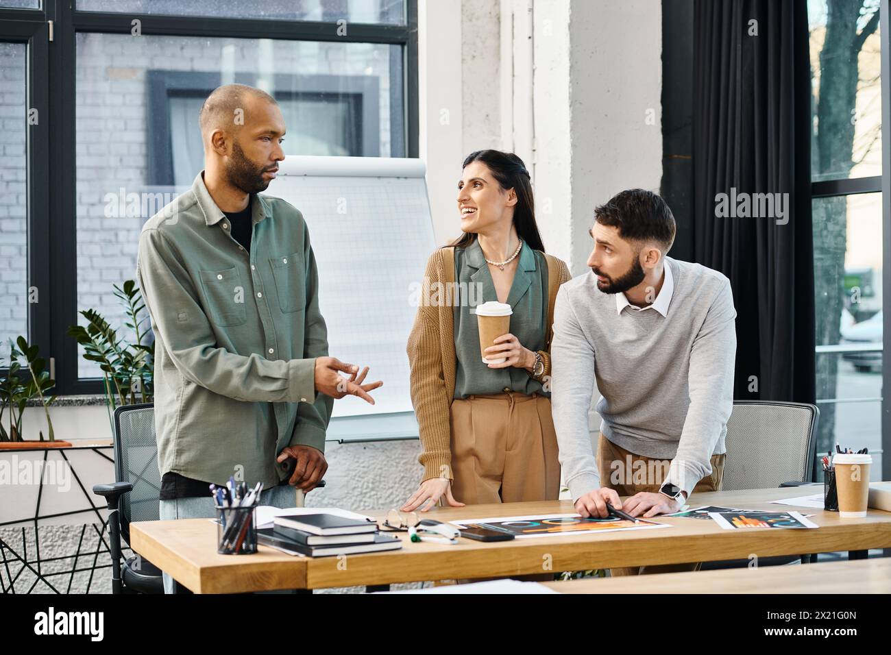 Diverse group of business professionals discussing project plans and ...