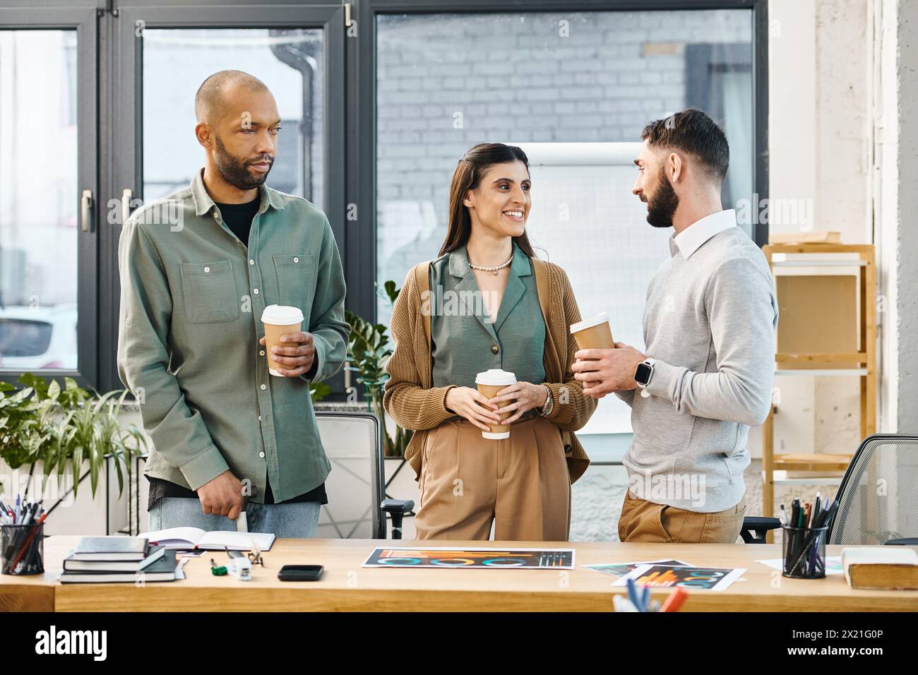 A diverse group of professionals standing around a table, engaged in ...