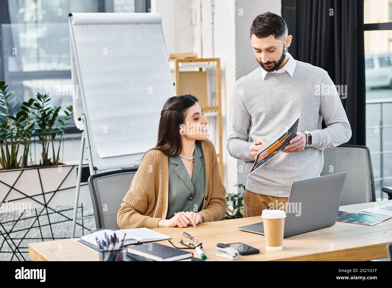 A man and woman engage in a productive discussion while seated at a ...