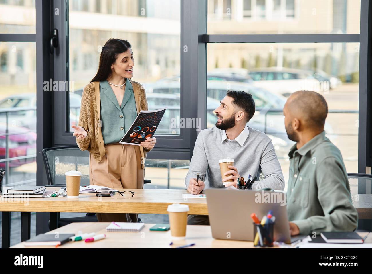 A diverse group of professionals engage in lively discussion around a ...