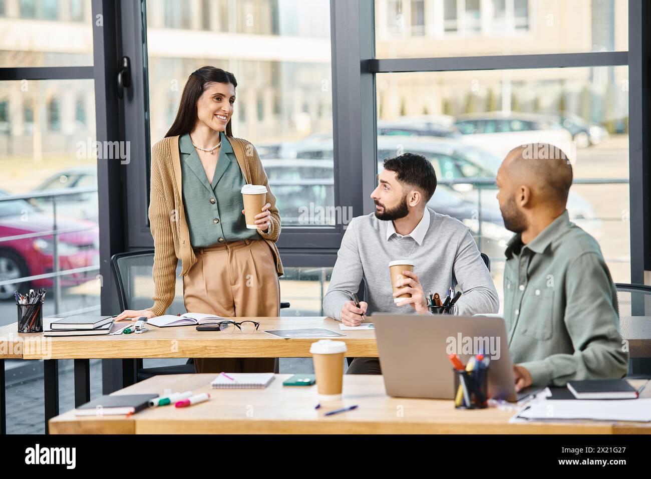 A diverse group of business professionals engaged in discussion and ...