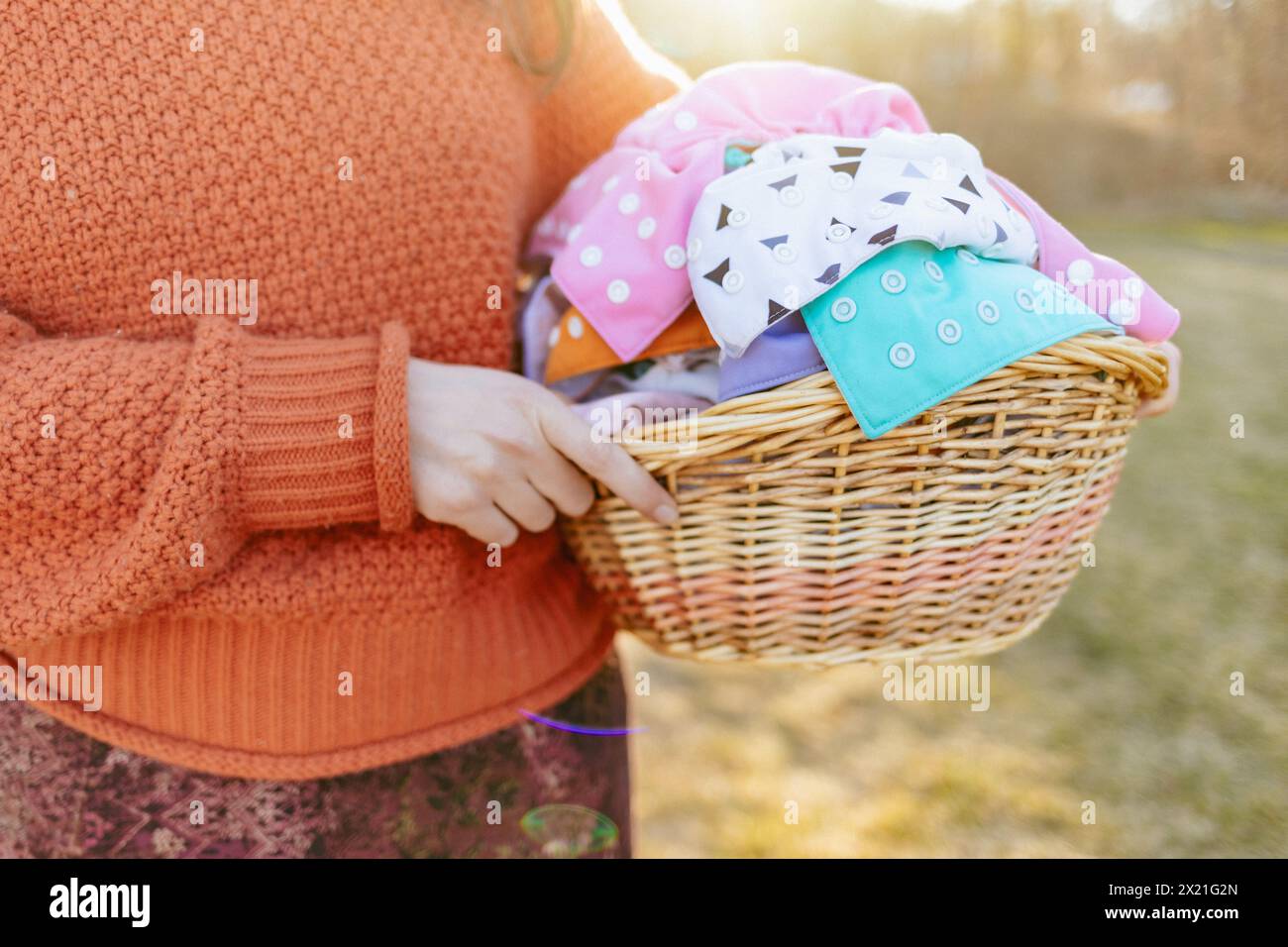 Women holding basket of cloth diapers to hang on the laundry line Stock ...