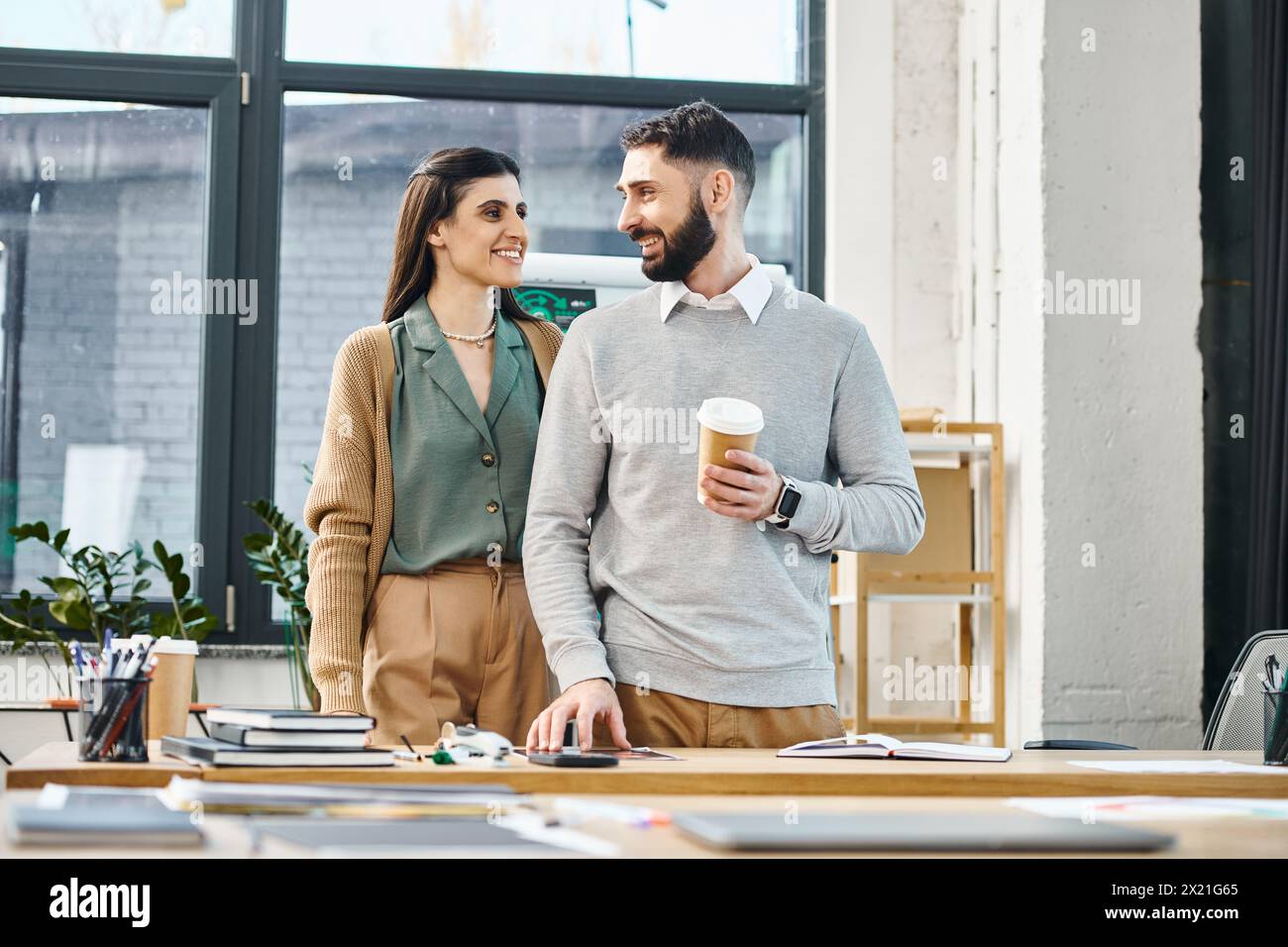 A man and a woman engage in productive discussion in a modern office ...