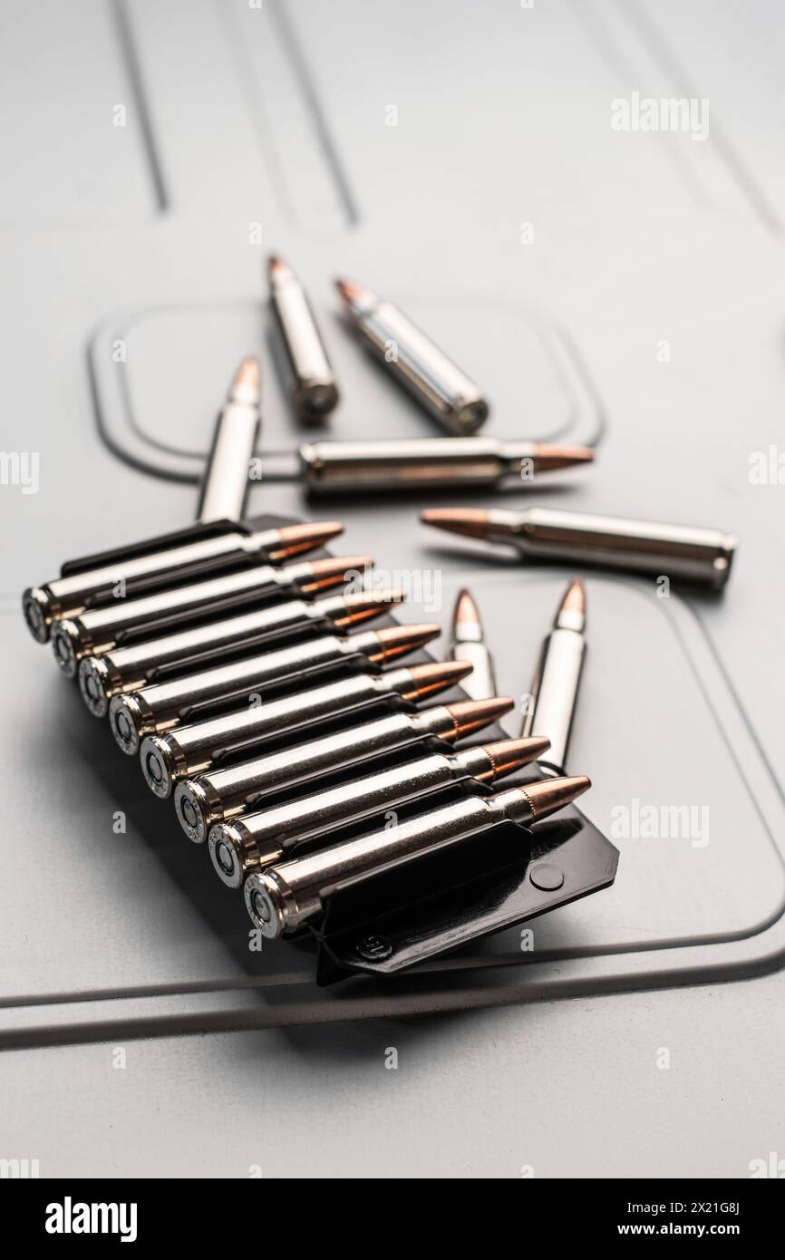 .223 caliber cartridges in silver cases on brushed metal. Ammunition ...