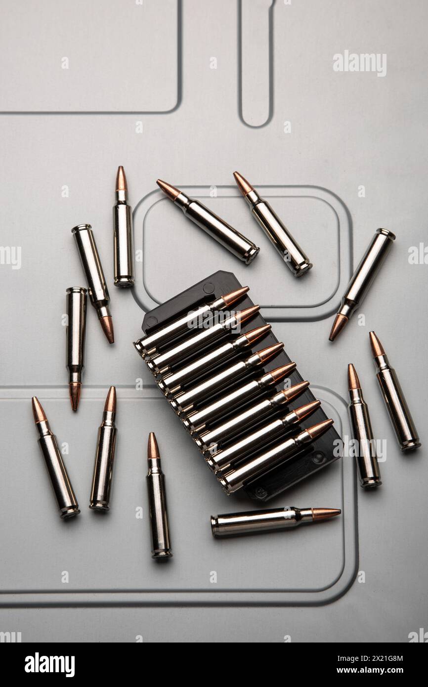 .223 caliber cartridges in silver cases on brushed metal. Ammunition ...