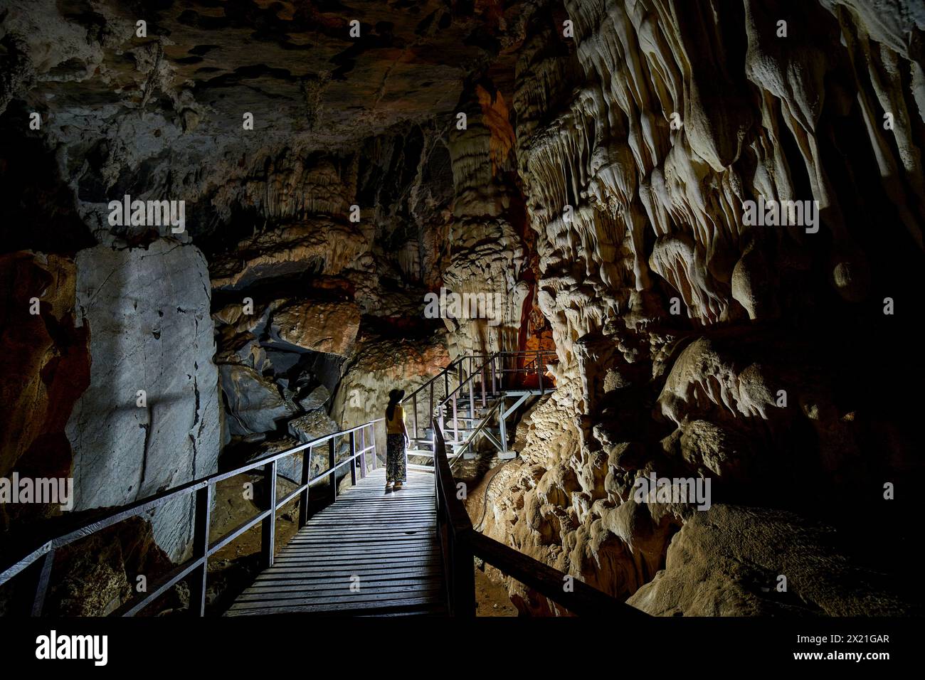 Woman standing alone in big cave Stock Photo - Alamy