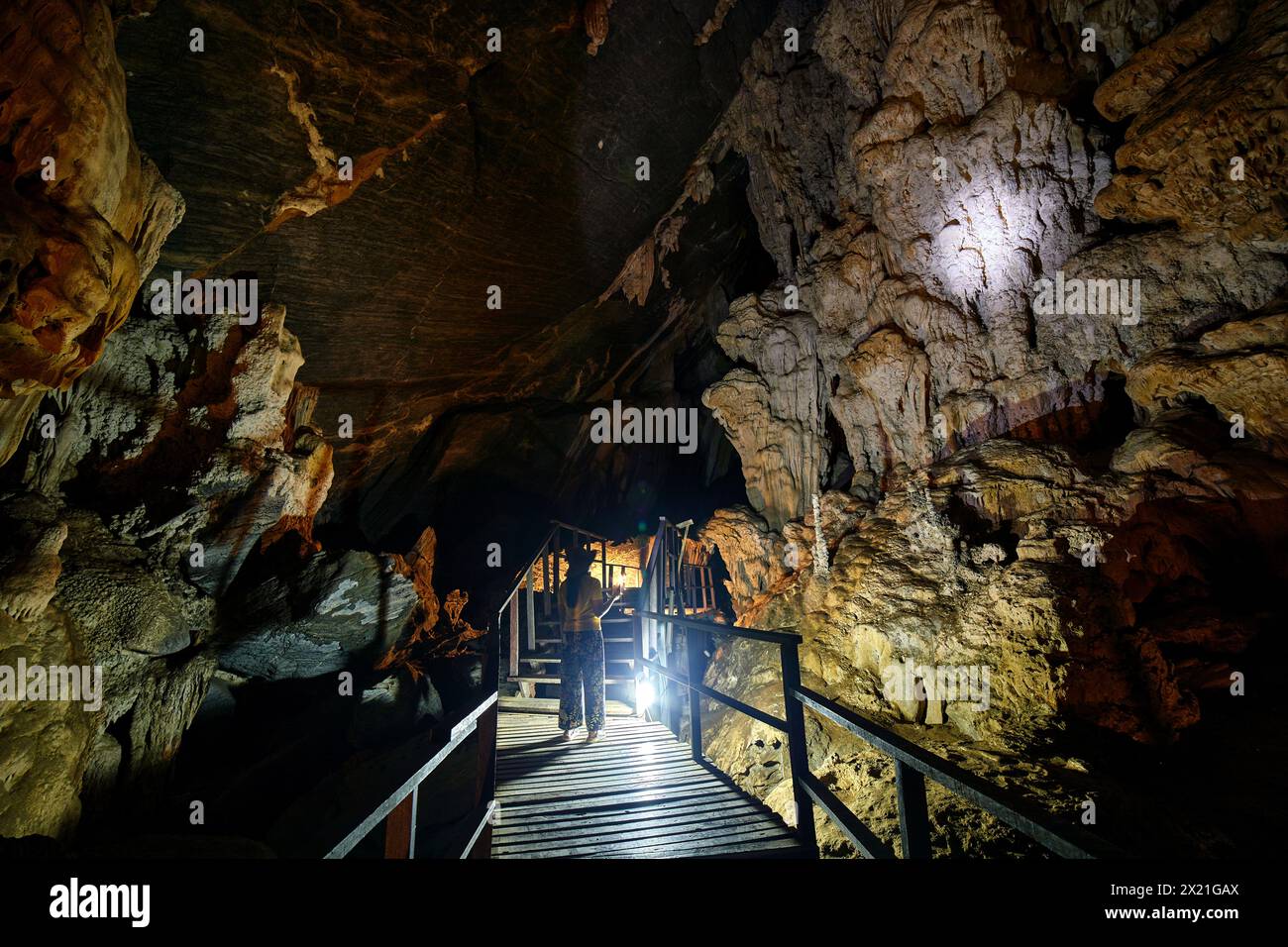 Woman standing alone in big cave Stock Photo - Alamy