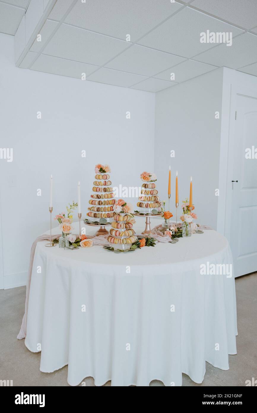 Macaroon Dessert Table with Candles and Florals Stock Photo - Alamy