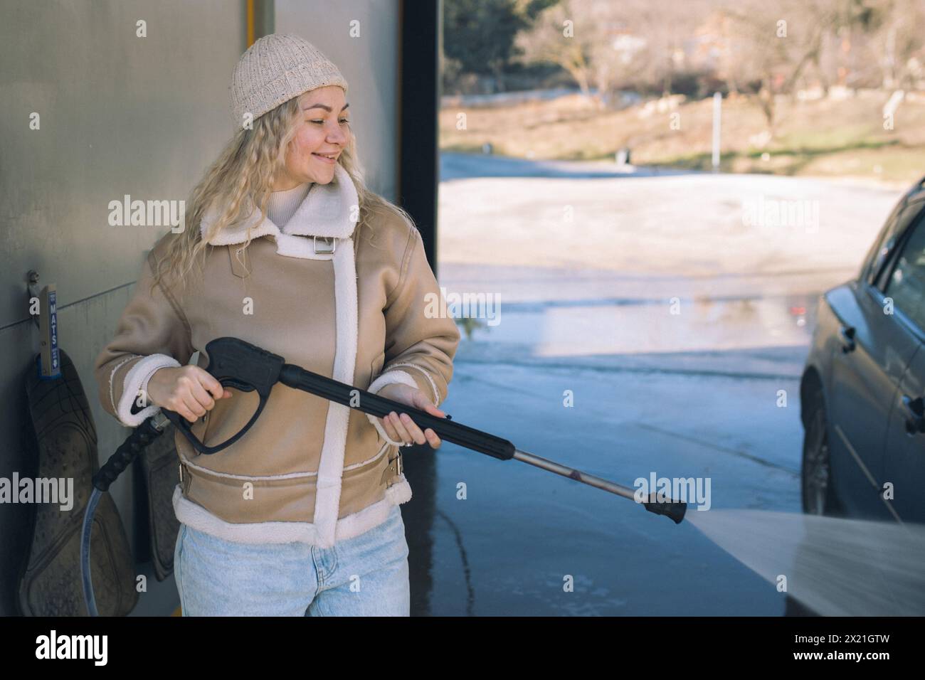 Beautiful young women washes the car at the self-service car wash Stock ...