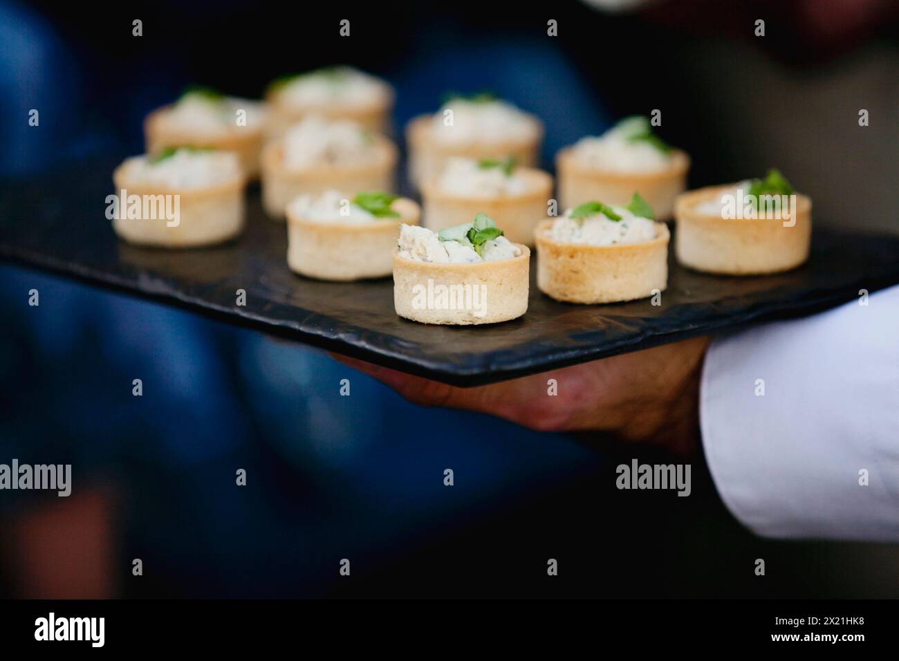 Hors d'oeuvres presented by server Stock Photo - Alamy