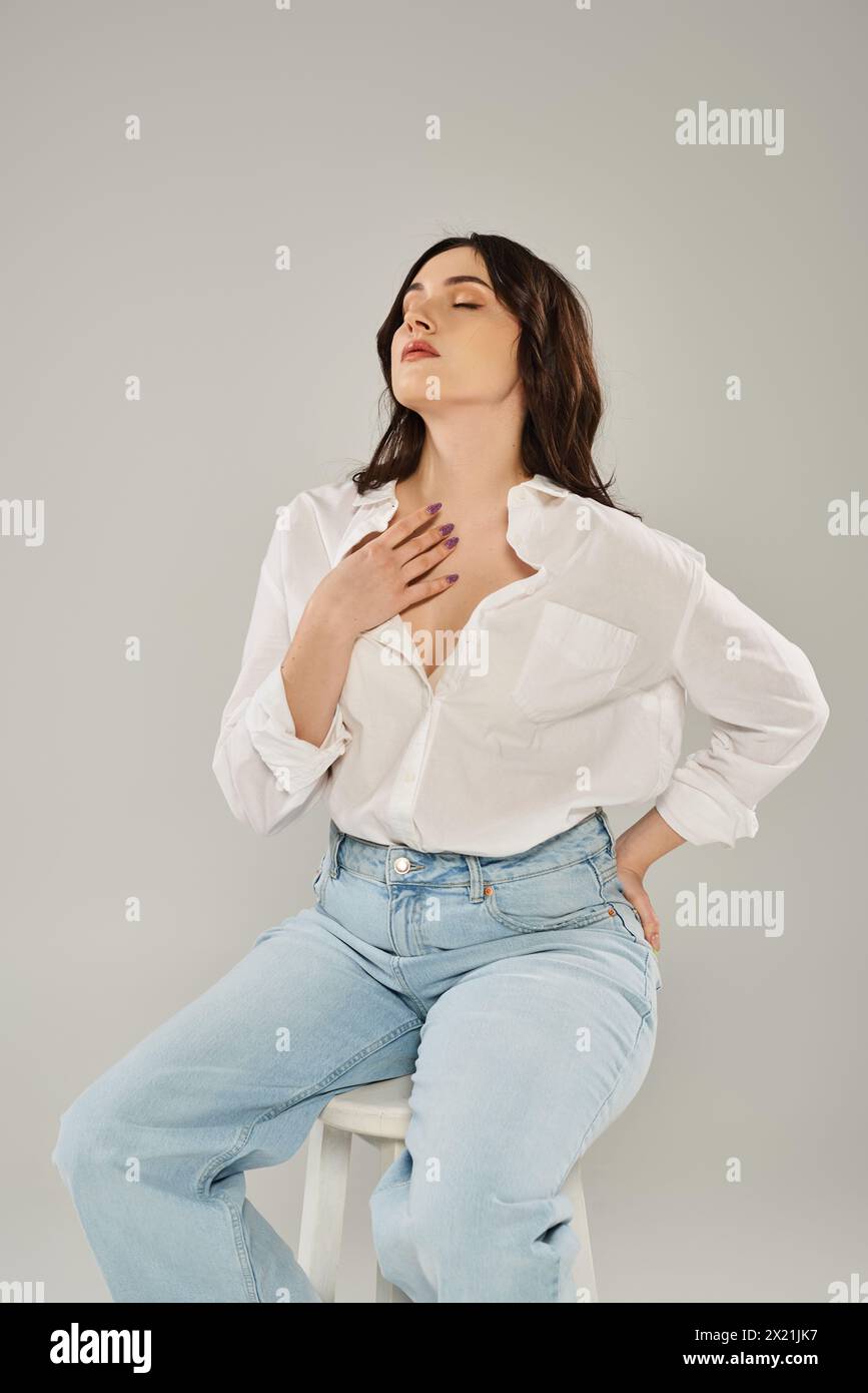 A beautiful plus size woman in stylish attire sitting on a stool ...